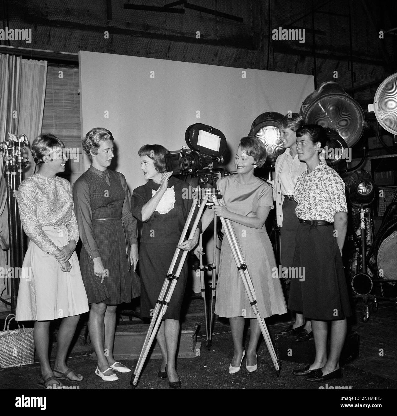 Olympic women swimmers get a first hand explanation of a movie camera ...