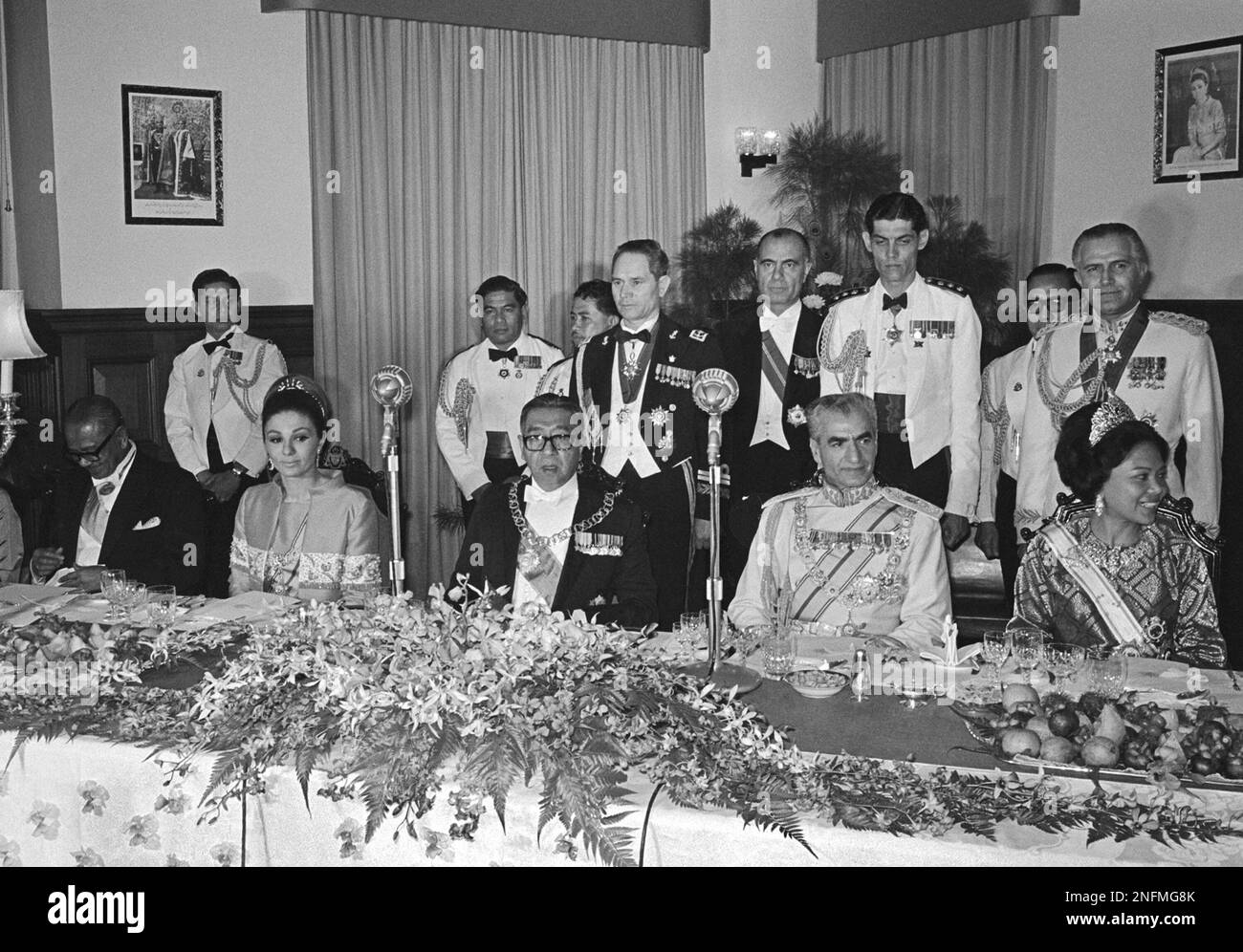 Iran's Shah Reza Pahlevi sits at the head table with his dinner guests ...