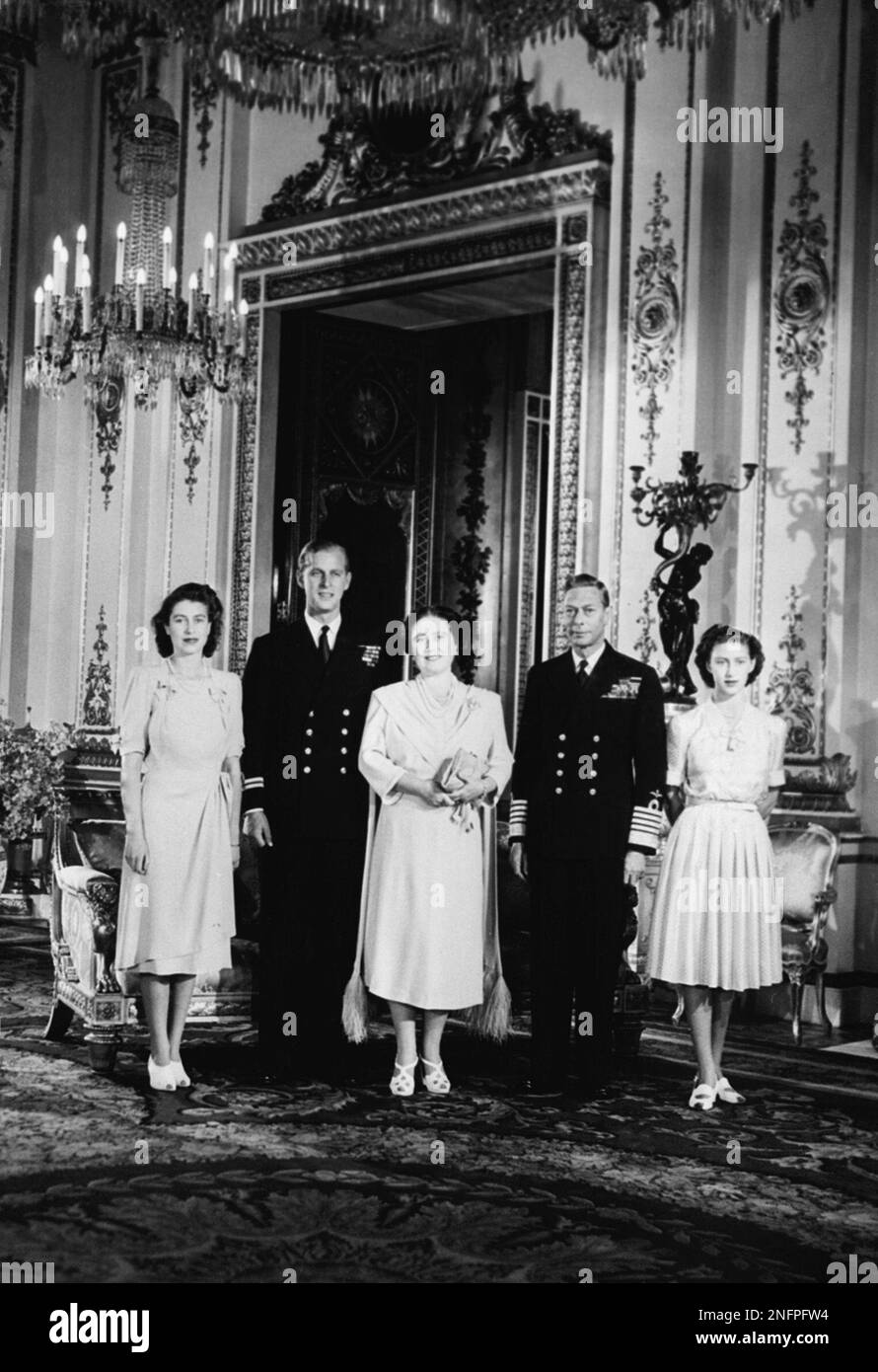 King George VI and his wife, Queen Elizabeth, stand with their daughter, Princess Elizabeth ...