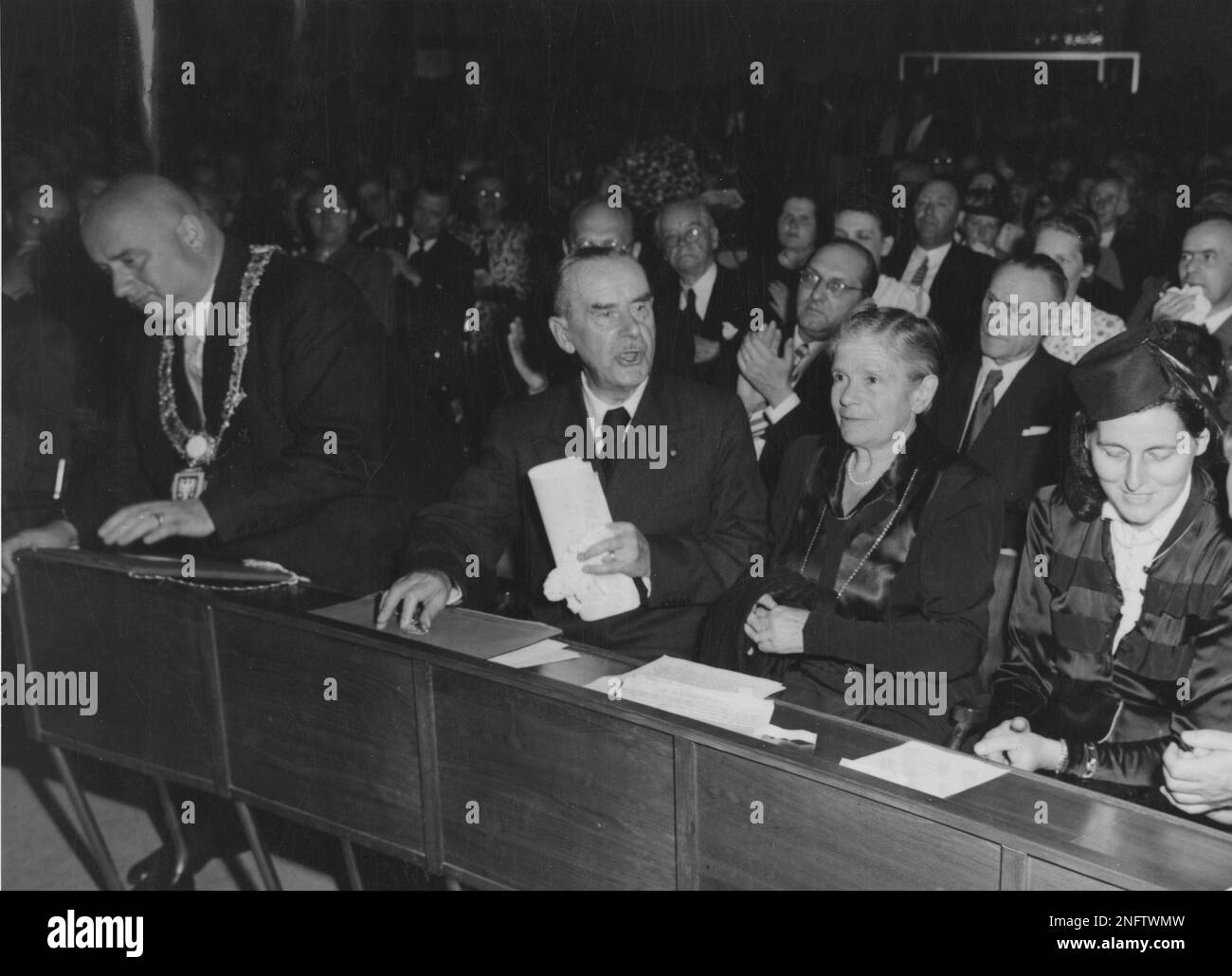 German dissident author, Thomas Mann, second from left sits on a bench ...