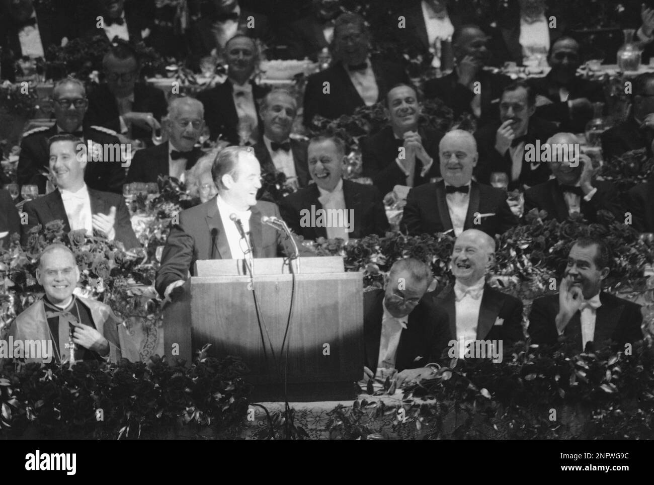 Vice President Hubert H. Humphrey casts a glance and a smile sideways ...
