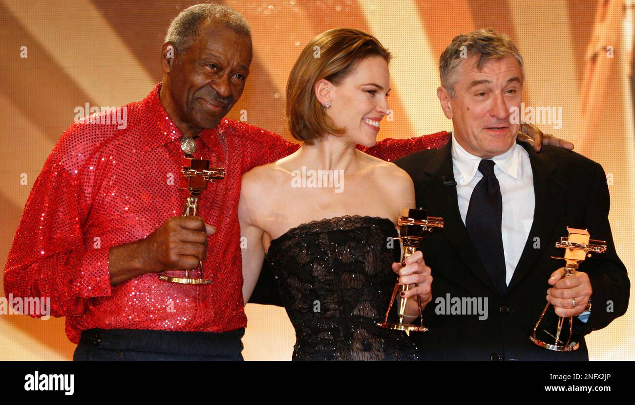 U.S. musician Chuck Berry, left, actress Hilary Swank, center, and ...