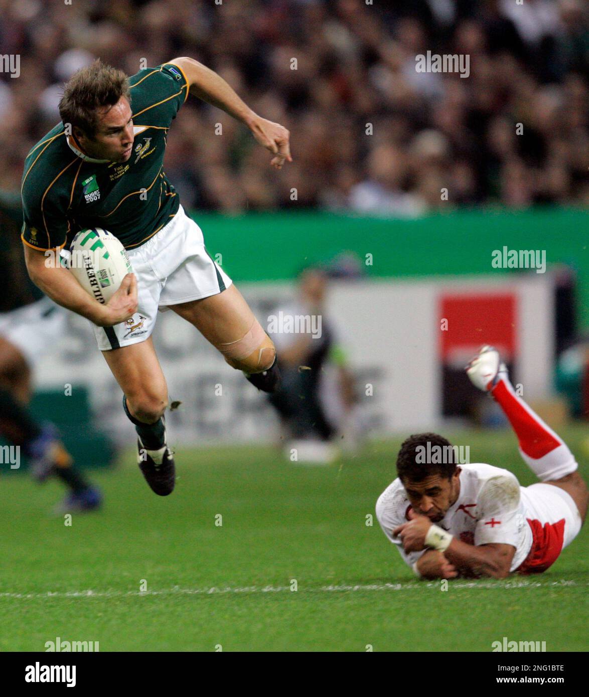 Butch James of South Africa, with ball, is being tackled by Jason ...