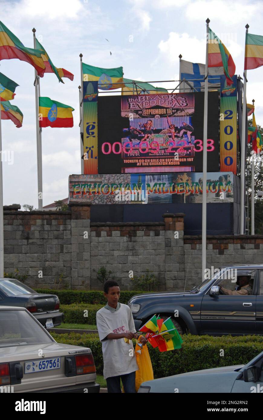 A young boy sells national flags in front of the Coptic millennium ...