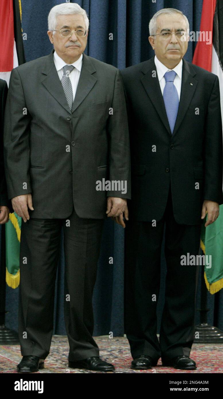 Newly-appointed Palestinian Prime Minister Salam Fayad, right, stands ...