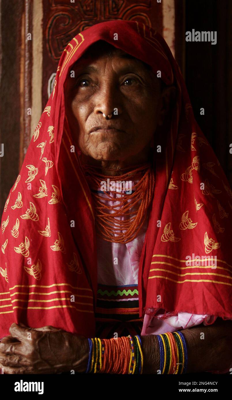 An old Kuna woman poses for a photo wearing her traditional dress in ...