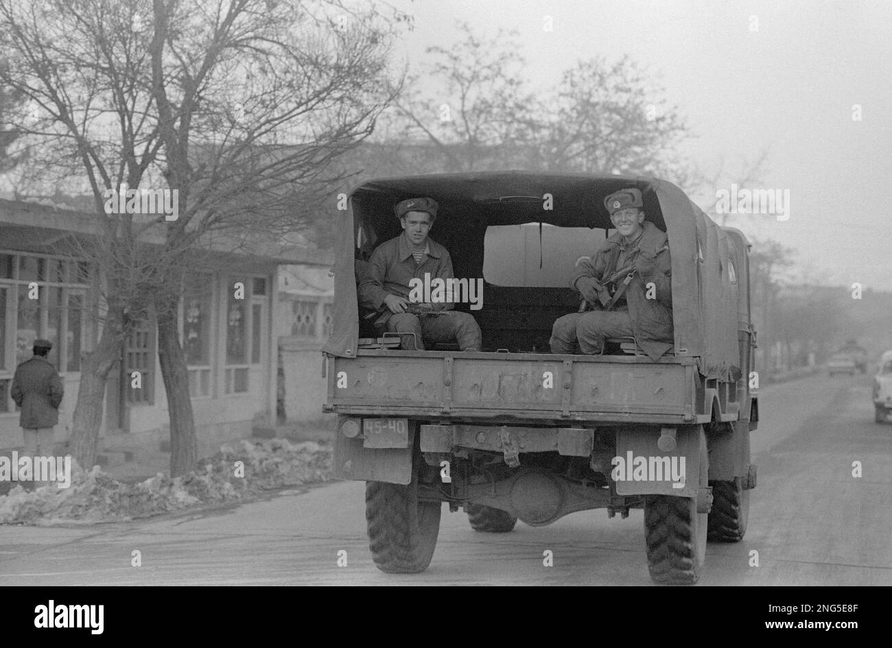 A Russian soldier flashes a broad grin from the back of the army truck ...