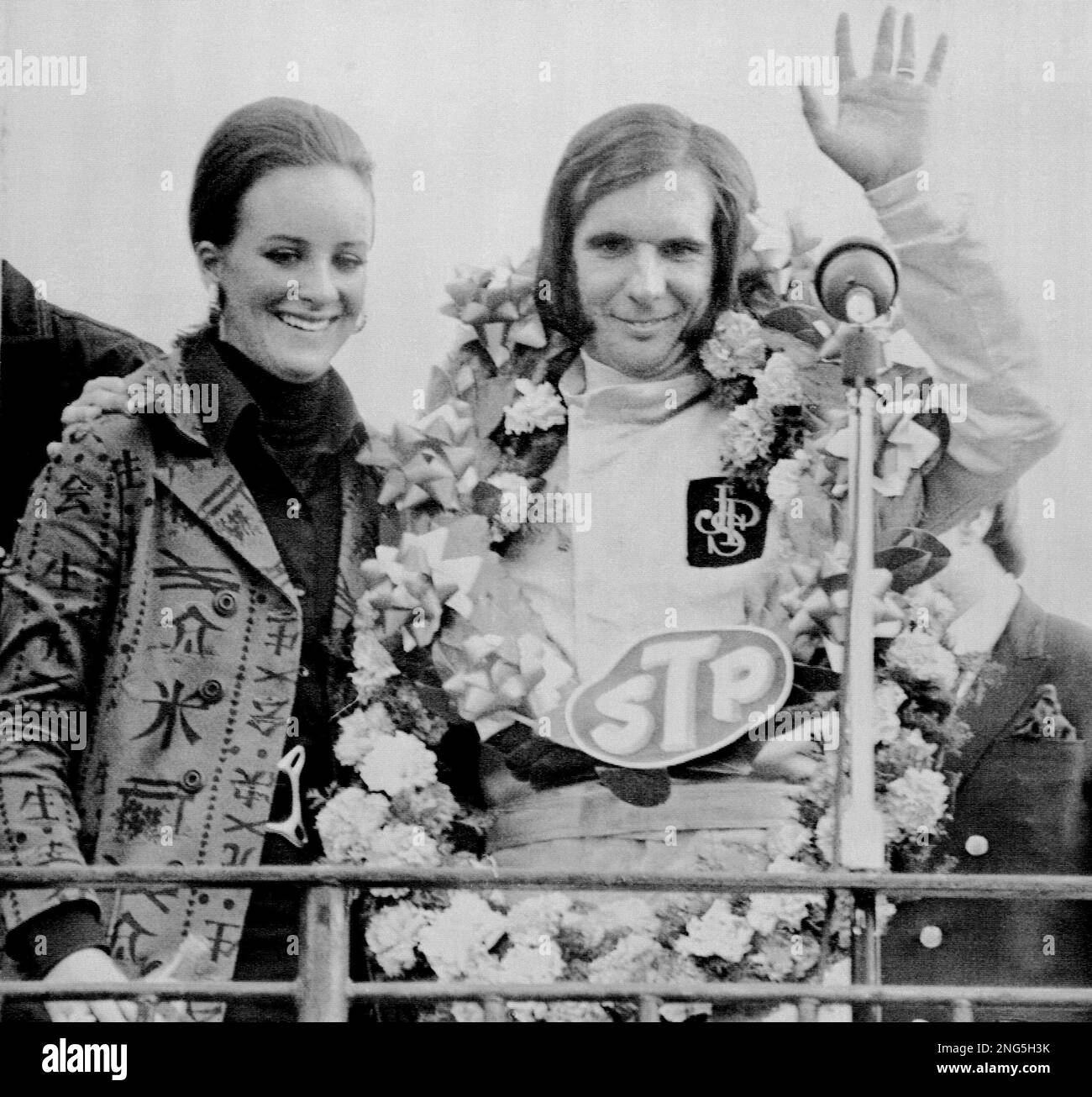 Emerson Fittipaldi, with his victory laurel wreath, waves with his wife ...
