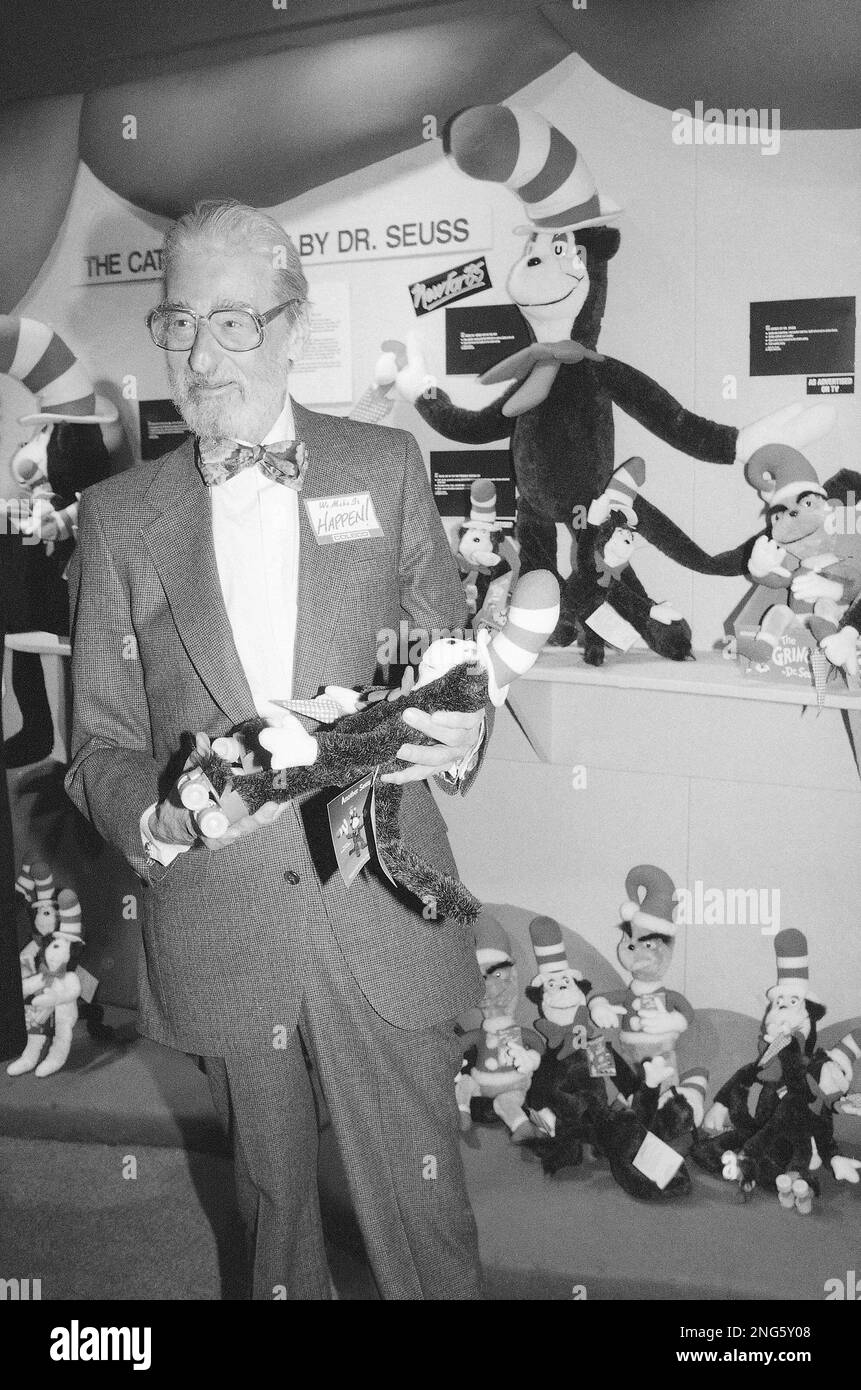 Author Dr. Seuss, alias Theodor S. Geisel, holds a Cat In The Hat toy ...