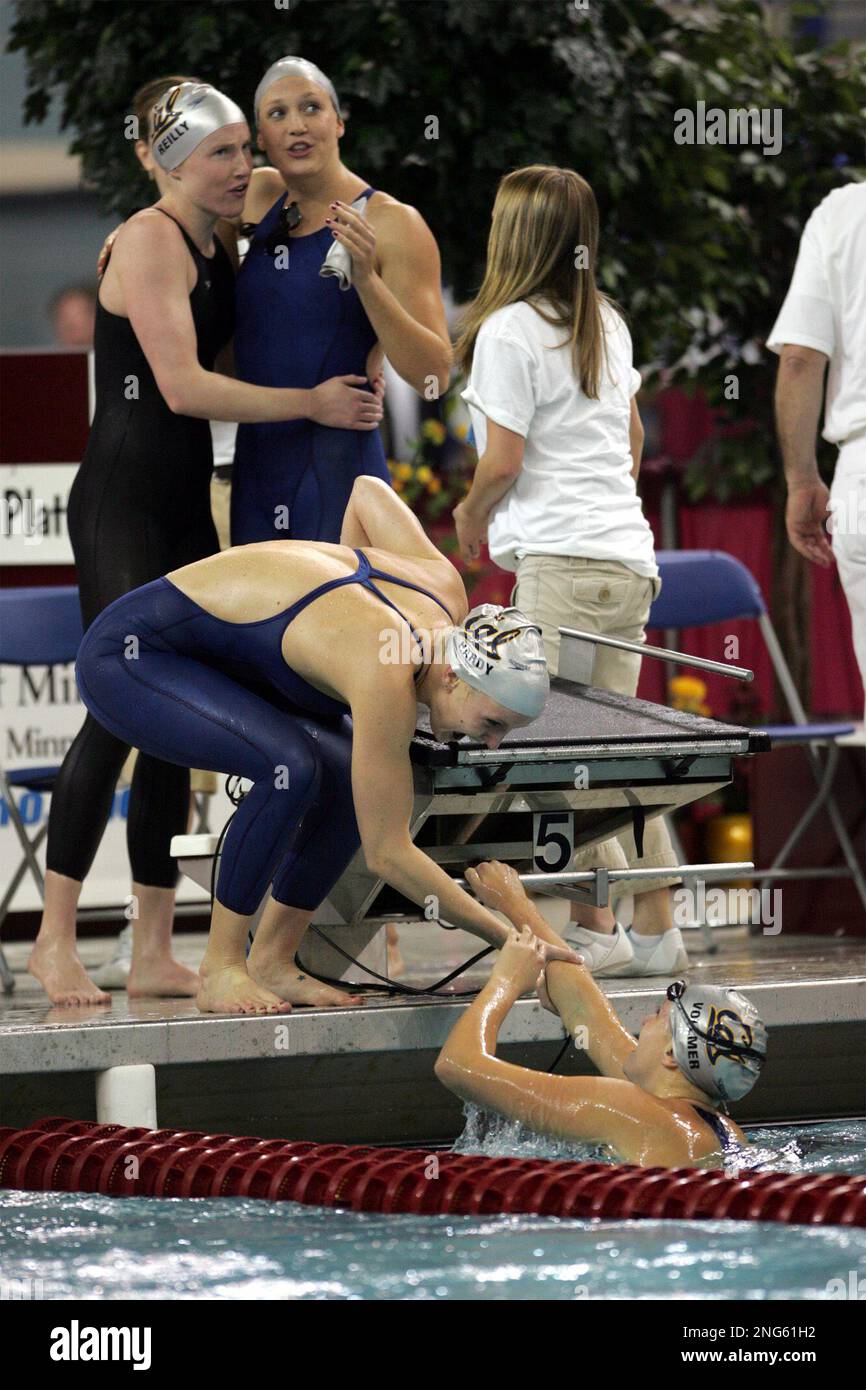 California's Jessica Hardy grabs the arm of teammate Dana Vollmer, in ...