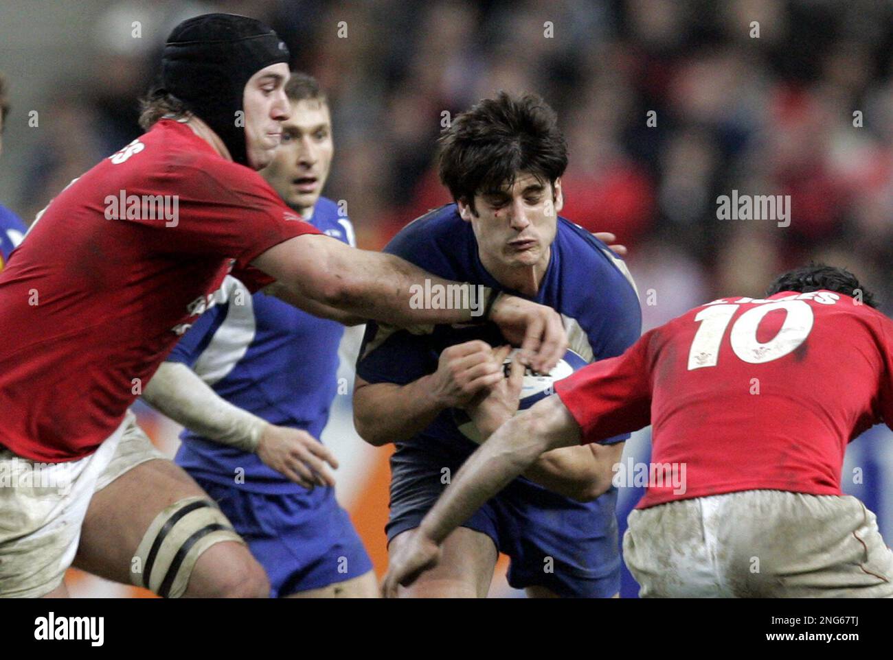 Wales' Ryan Jones, left, and Stephen Jones, right, try to tackle David ...
