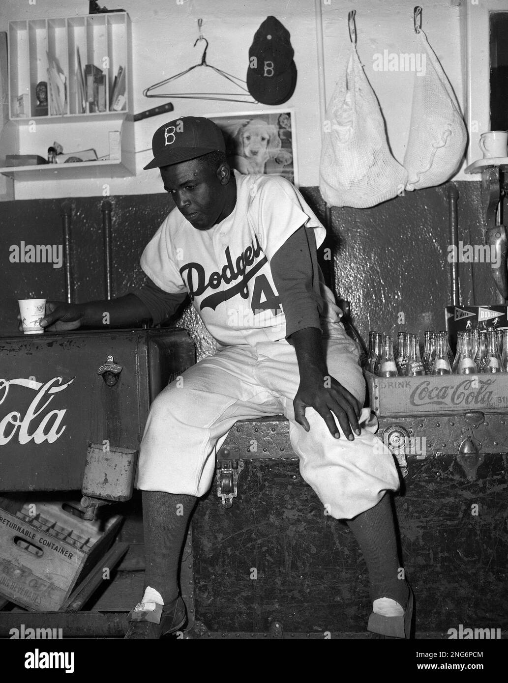 Brooklyn Dodgers' second baseman Jackie Robinson sits dejectedly in the ...