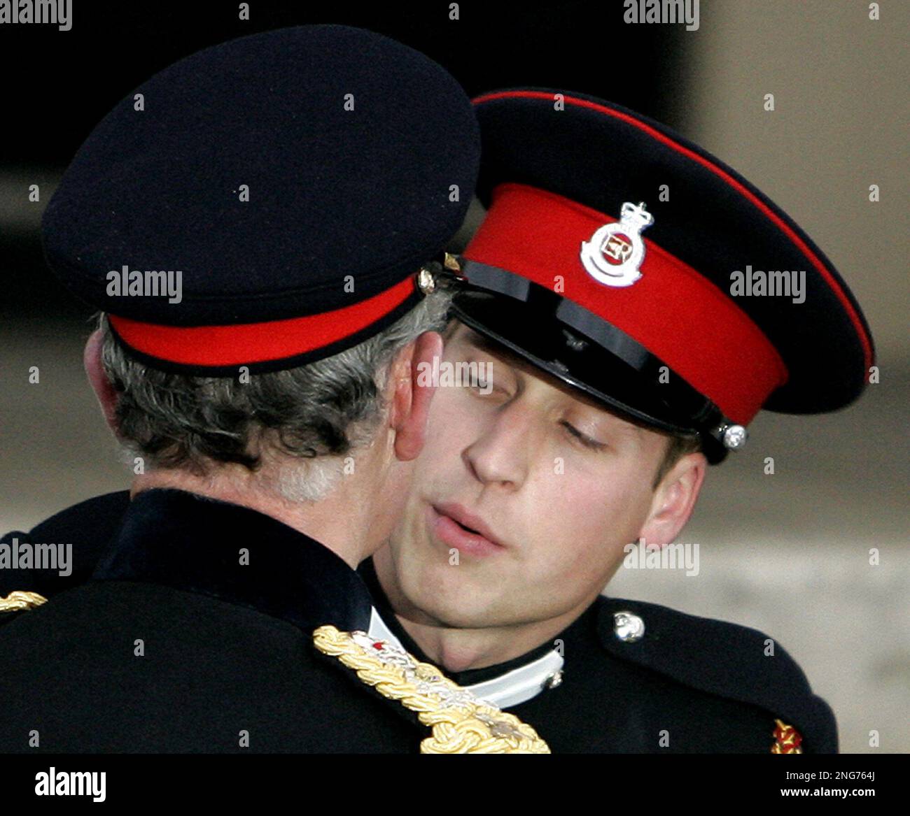 Britain's Prince William, right, kisses his father, Prince Charles ...