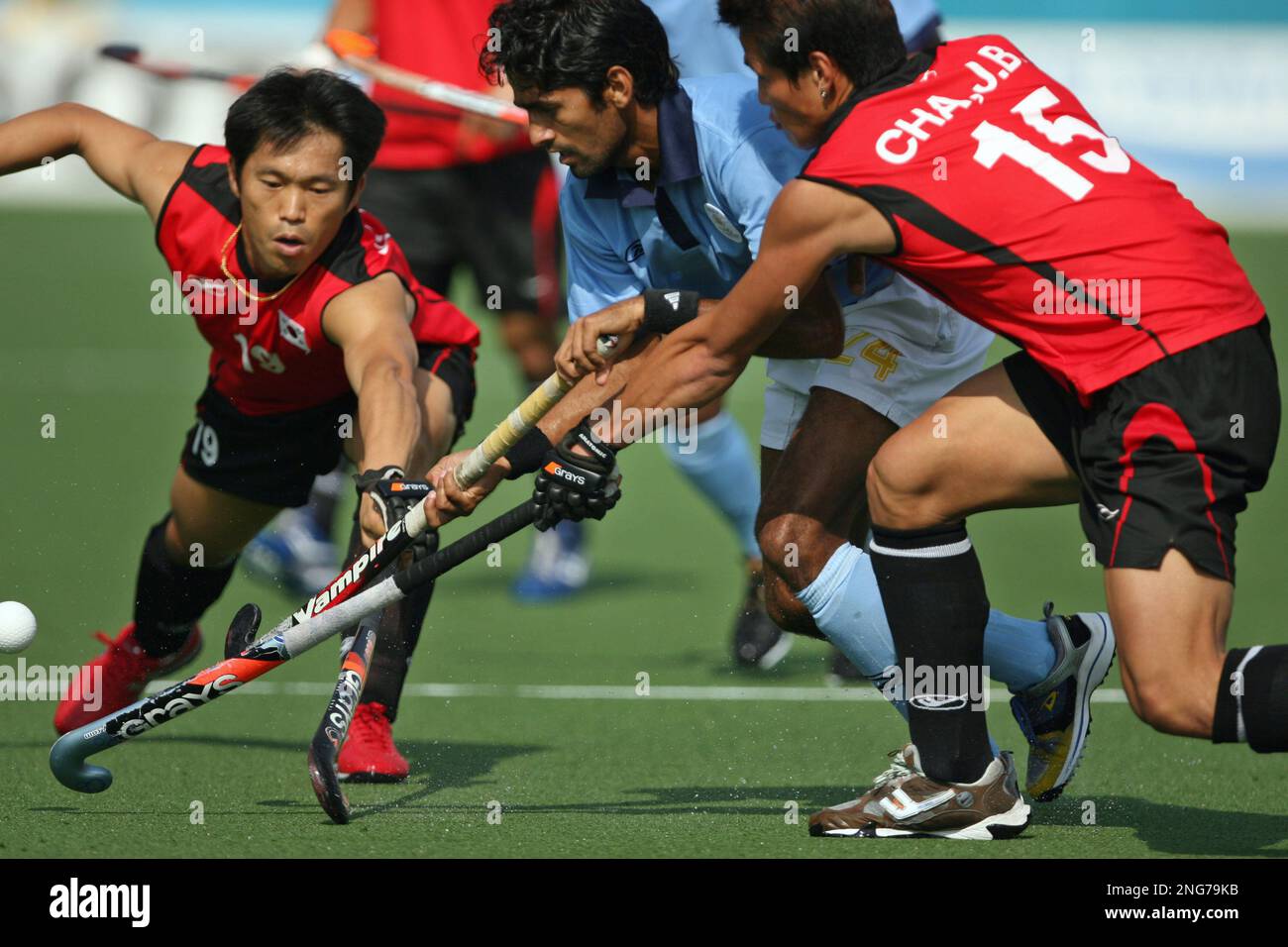 India's Shivendra Singh, center, fights for the ball with South Korea's Yeo Woo-kon (19), left ...