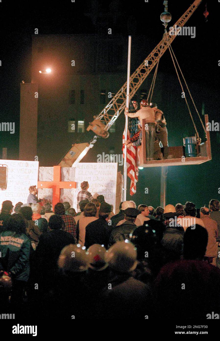 A flag is mounted at half staff during a memorial on the site of a ...