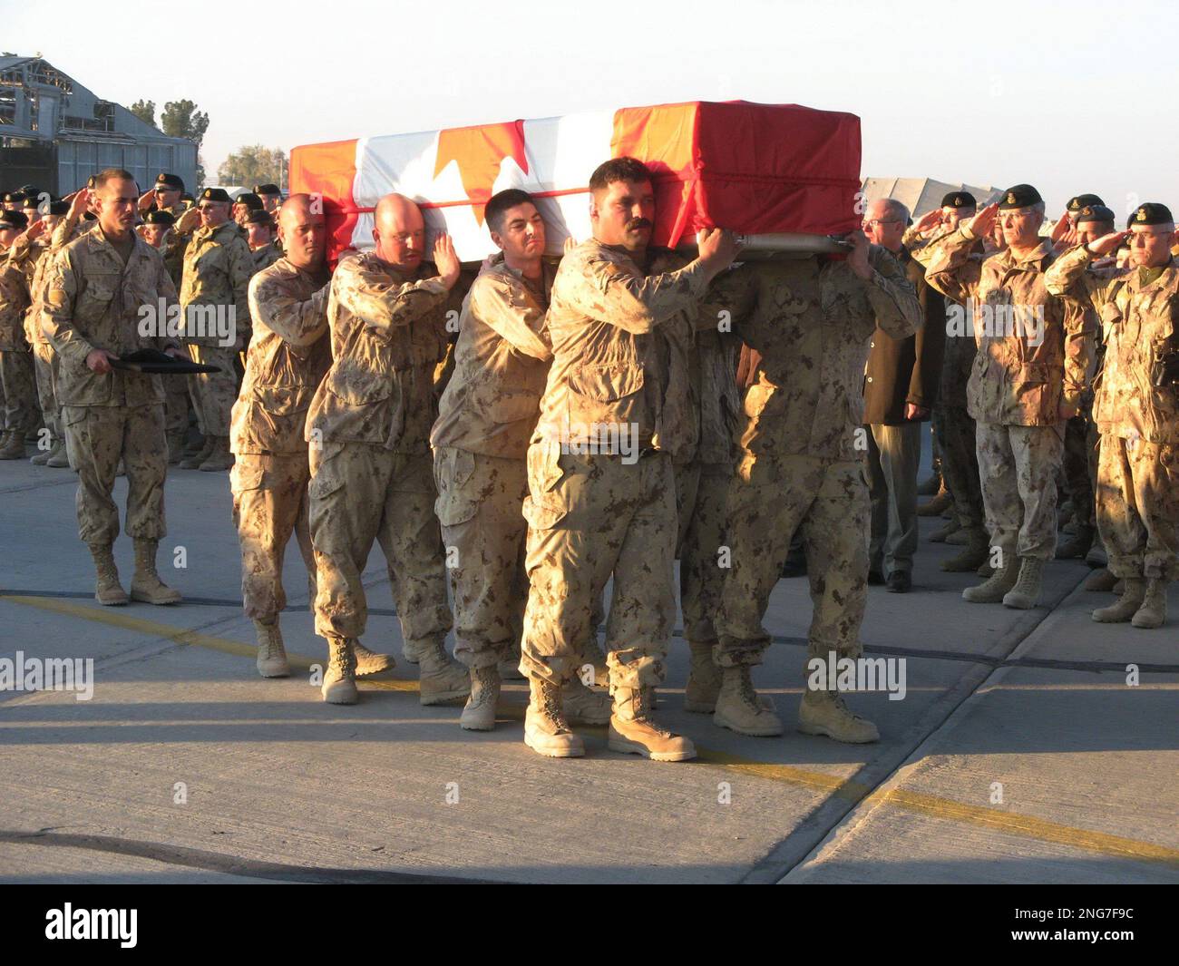 Soldiers carry a coffin of a Canadian soldier during a ramp ceremony at ...