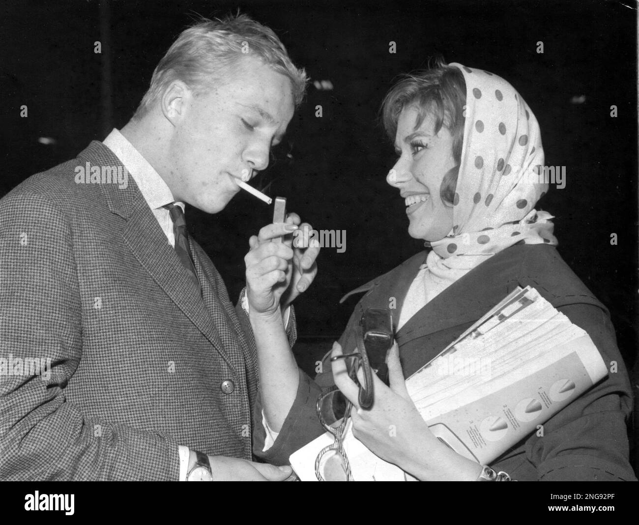 German actress Kai Fischer lights a cigarette for her boy friend Alfred ...