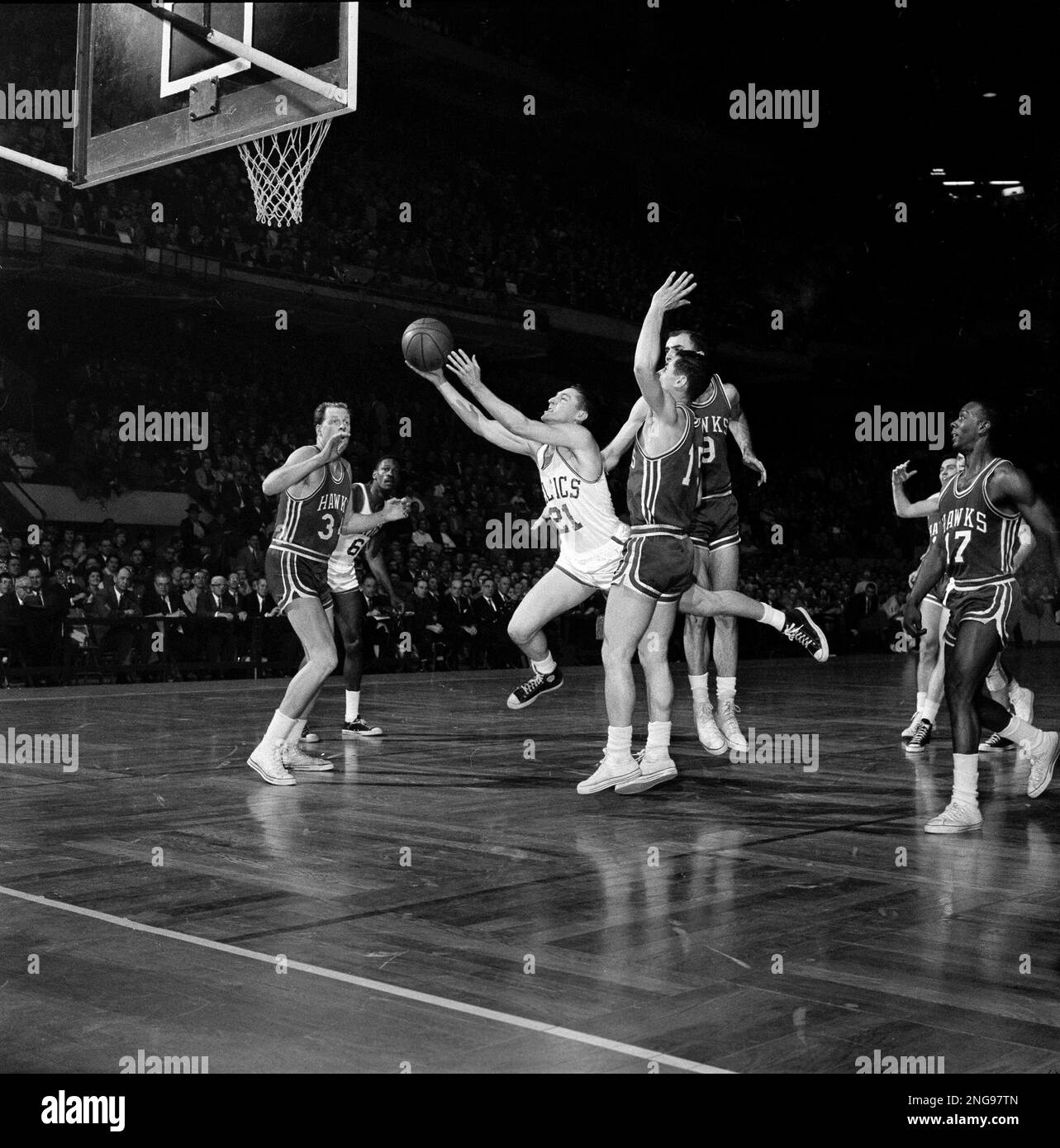 Bill Sharman, Boston Celtics' player, (21), flies through John McCarthy ...