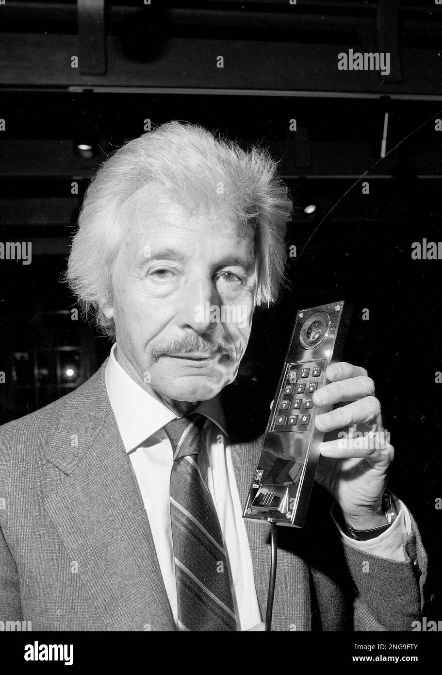 Paris-born fashion designer Oleg Cassini displays a gold-plated version ...