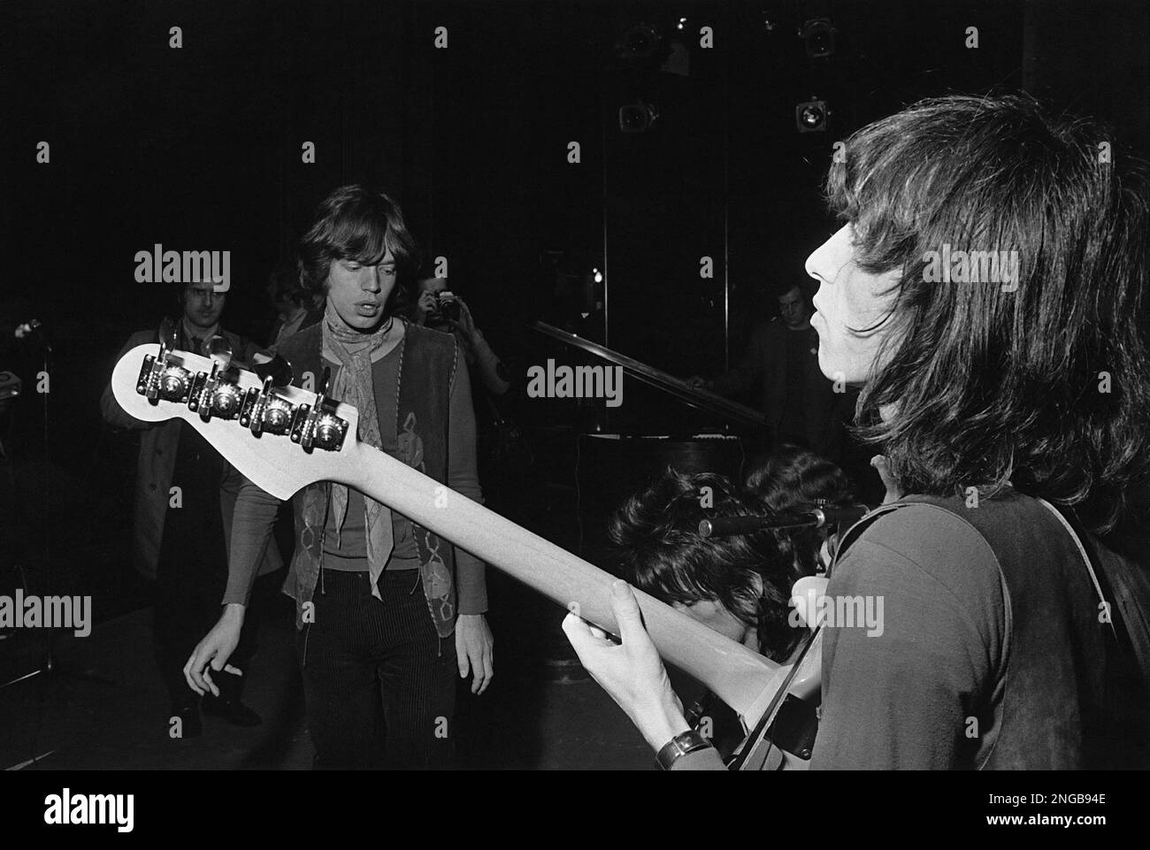 Rolling Stones lead singer Mick Jagger is framed by the guitar of ...