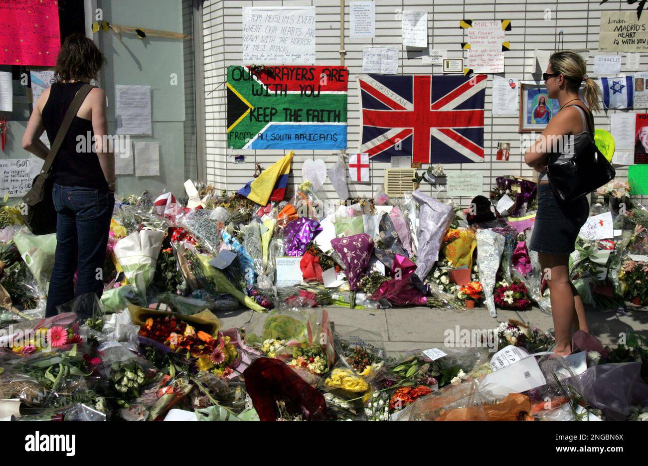 Members of the public visit the floral tributes outside King's Cross ...
