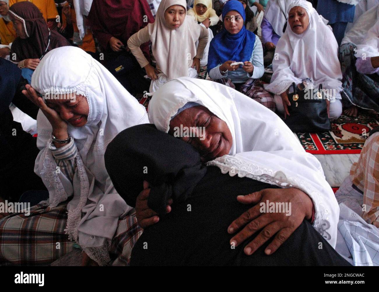 Muslim women cry at an Eid al-Adha prayer service at Raya Baiturrahman ...