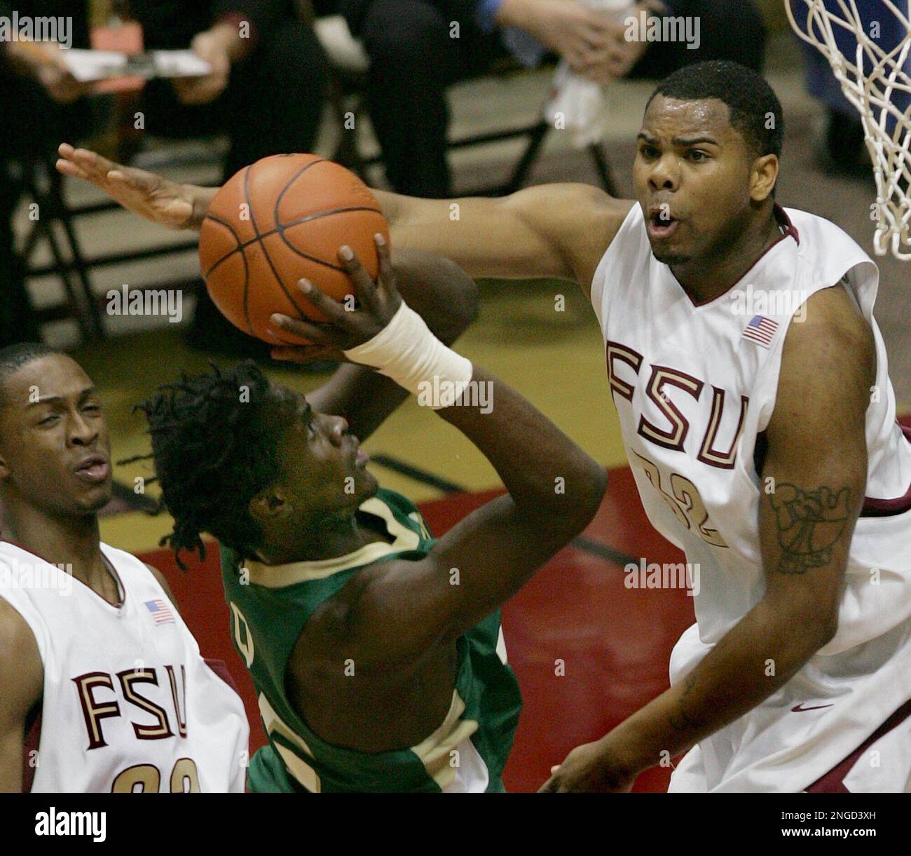 Jacksonville's Haminn Quaintance, center, scores between Florida State ...