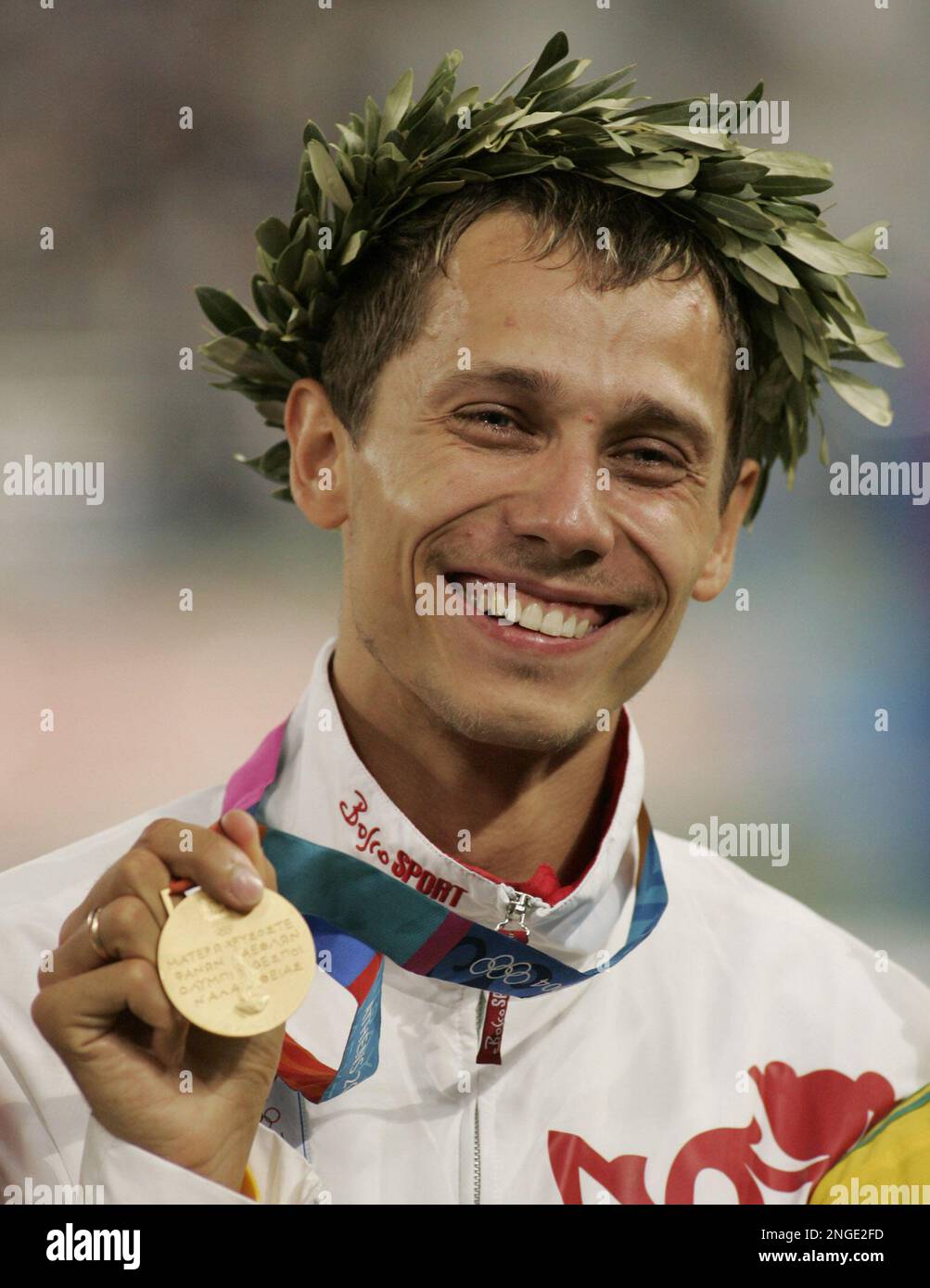 Men's 800 meter gold medalist Yuriy Borzakovskiy holds his medal ...