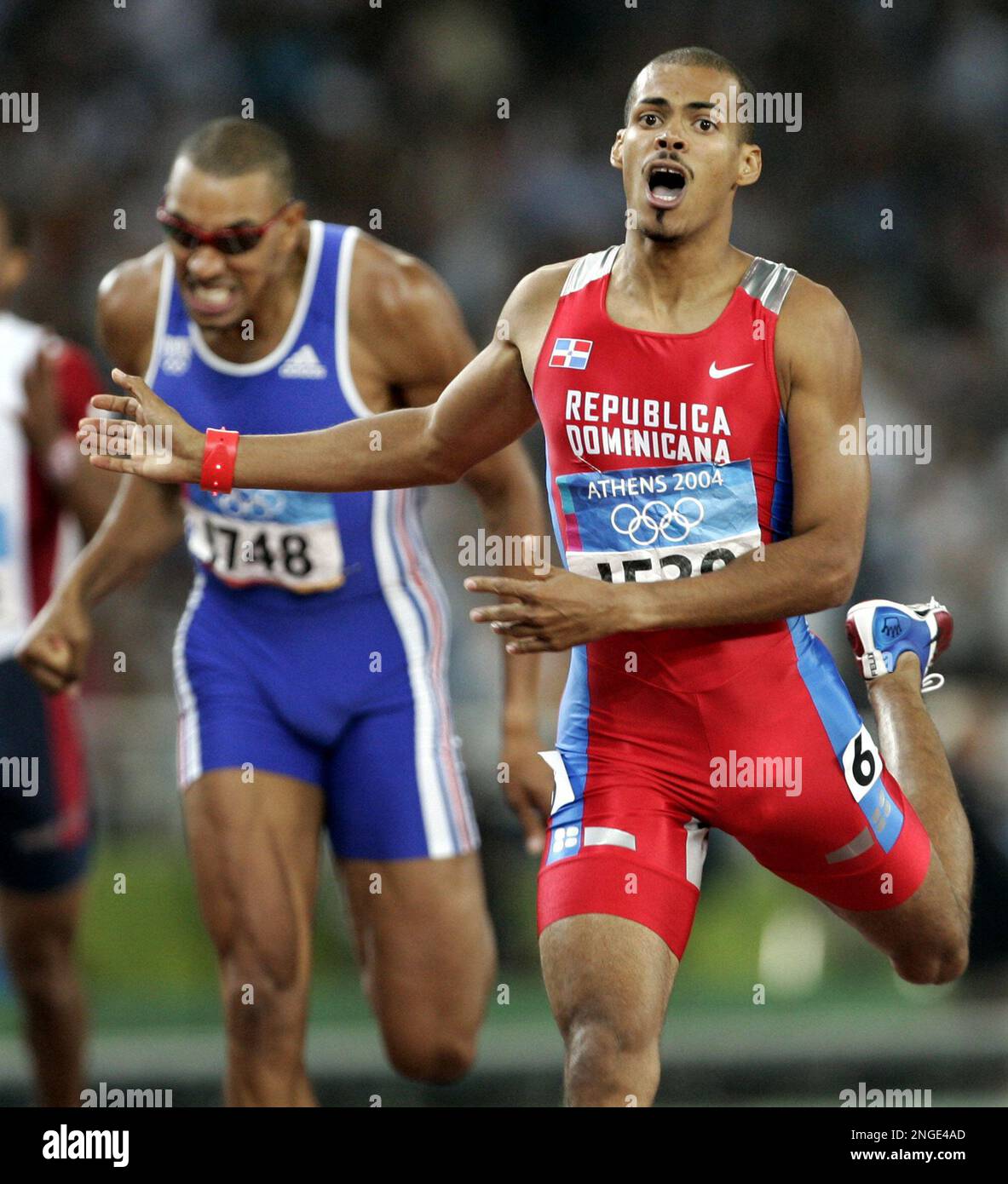 Felix Sanchez, of the Domincan Republic, reacts as he crosses the ...