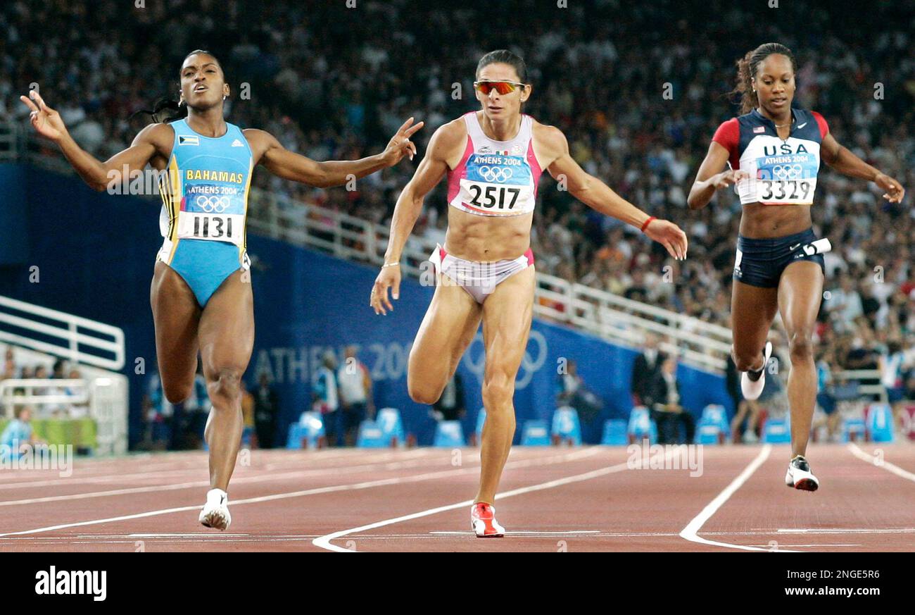 Gold medal winner Tonique Williams-Darling, left, of the Bahamas, with ...