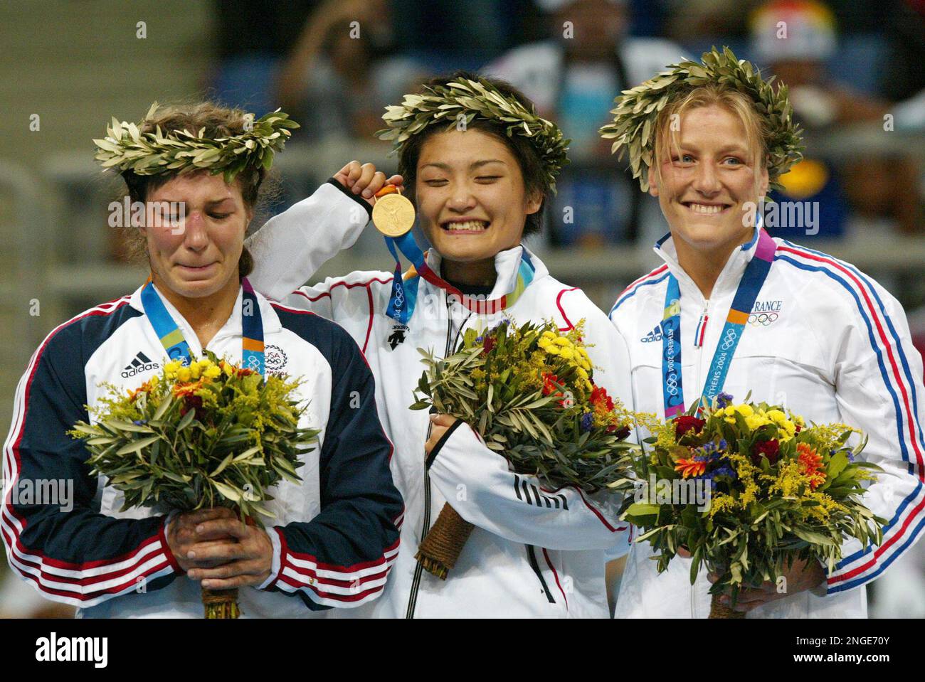 The winners of the women's freestyle 63kg wrestling competition pose ...