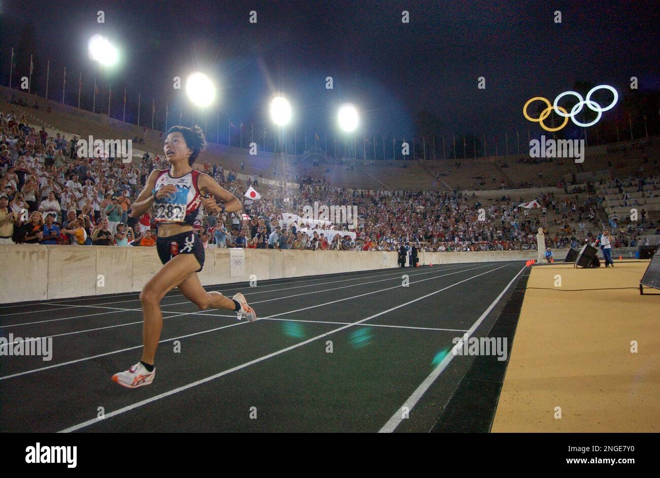 Japan's Mizuki Noguchi takes the final lap inside the Panathinaiko ...