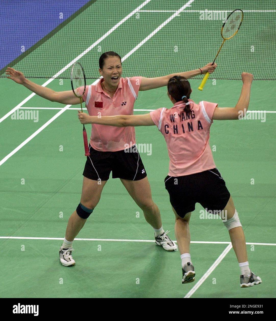 China's Zhang Jiewen, and her partner Yang Wei celebrate winning the gold medal after defeating ...