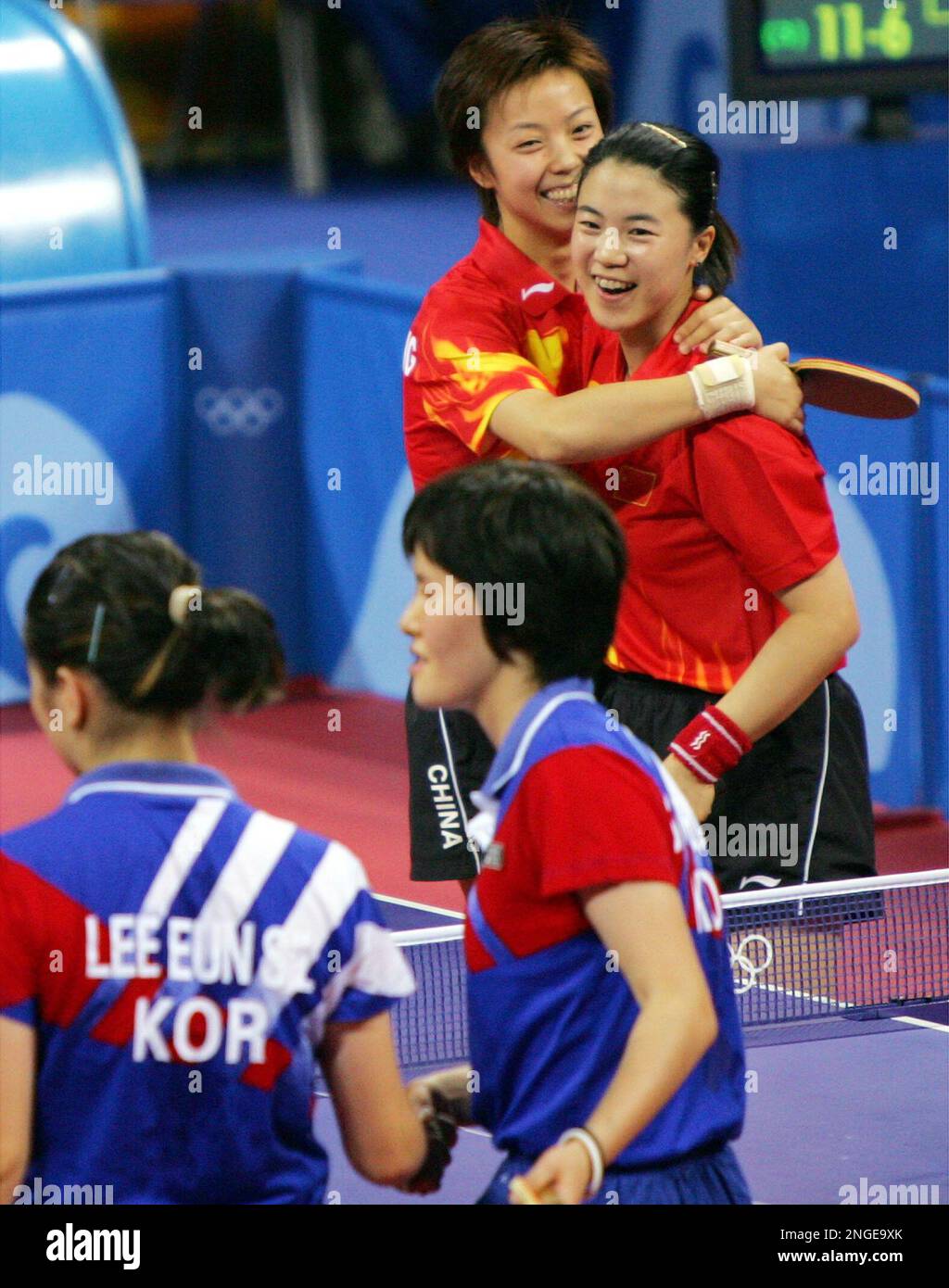 Zhang Yining of China, back left, and her partner Wang Nan, back right ...