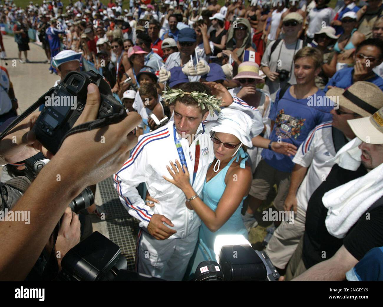 Press photographers and fans gather around bronze medalist Fabien ...