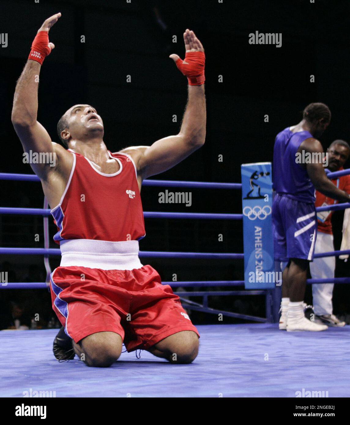 Egypt's Mohamed Aly, left, kneels on the canvas and prays after ...