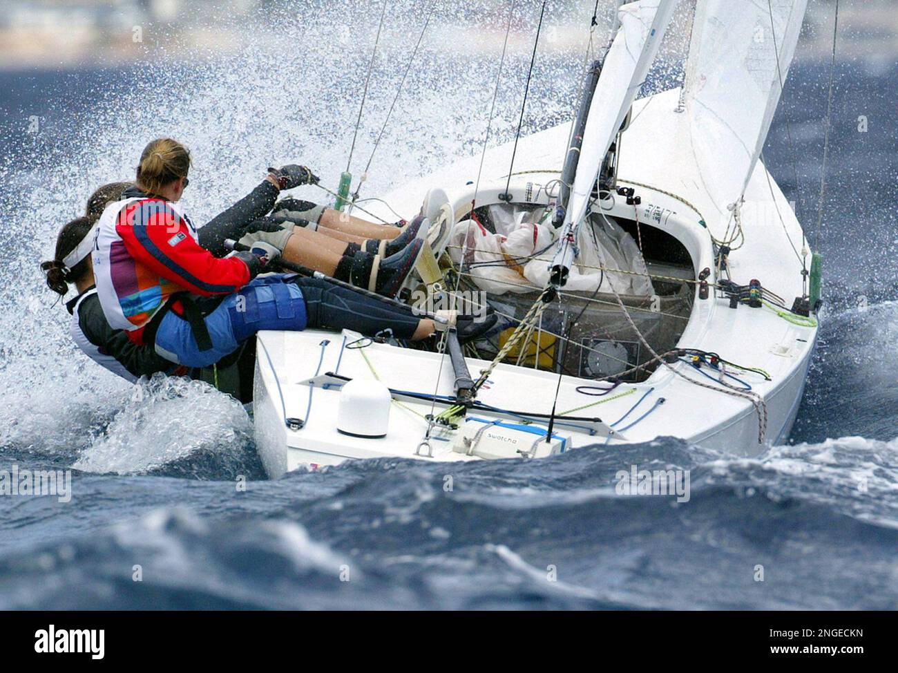 Germany's three-women Yngling keelboat crew crashes into a wave during ...