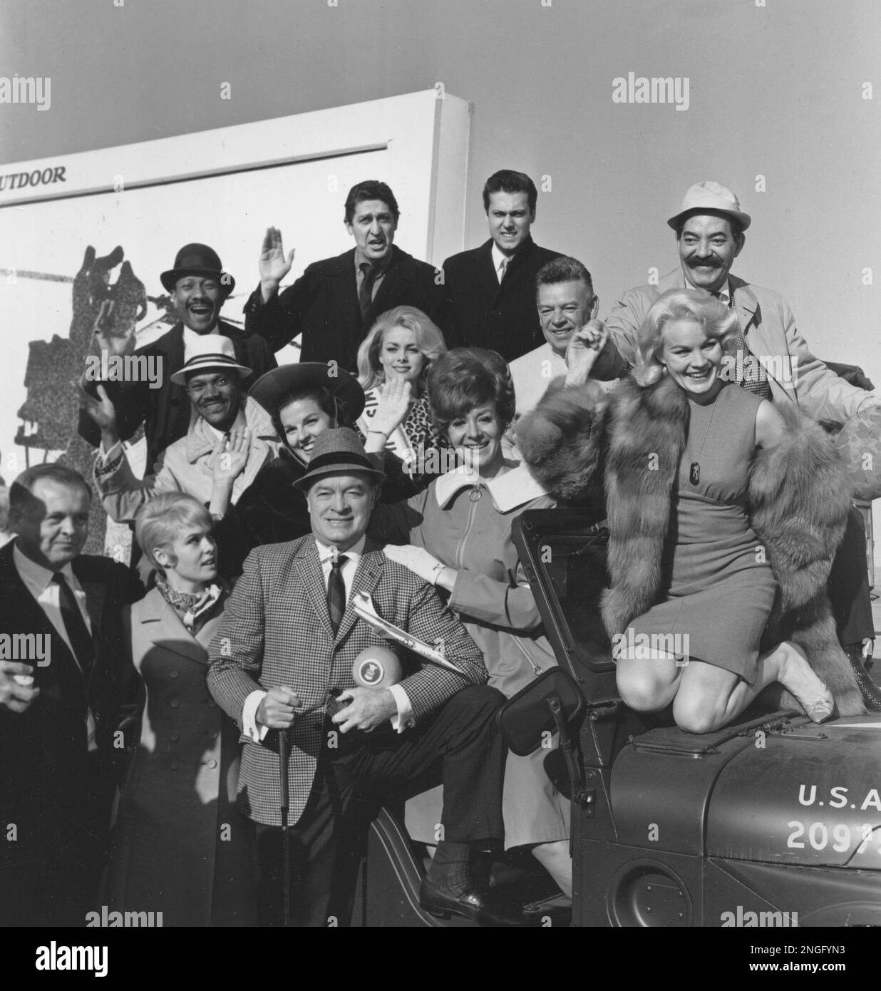 Bob Hope poses with entertainers and comedians on a U.S. Army jeep at ...
