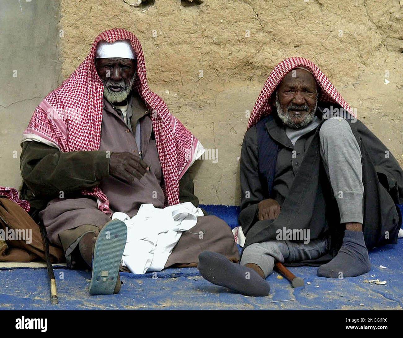 Saudi men chat outside their homes, Dec. 22, 2002, in the al-Aoud ...