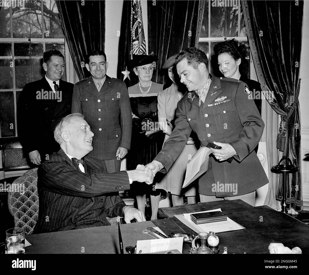 President Franklin D. Roosevelt shakes the hand of First Lt. Jack C ...