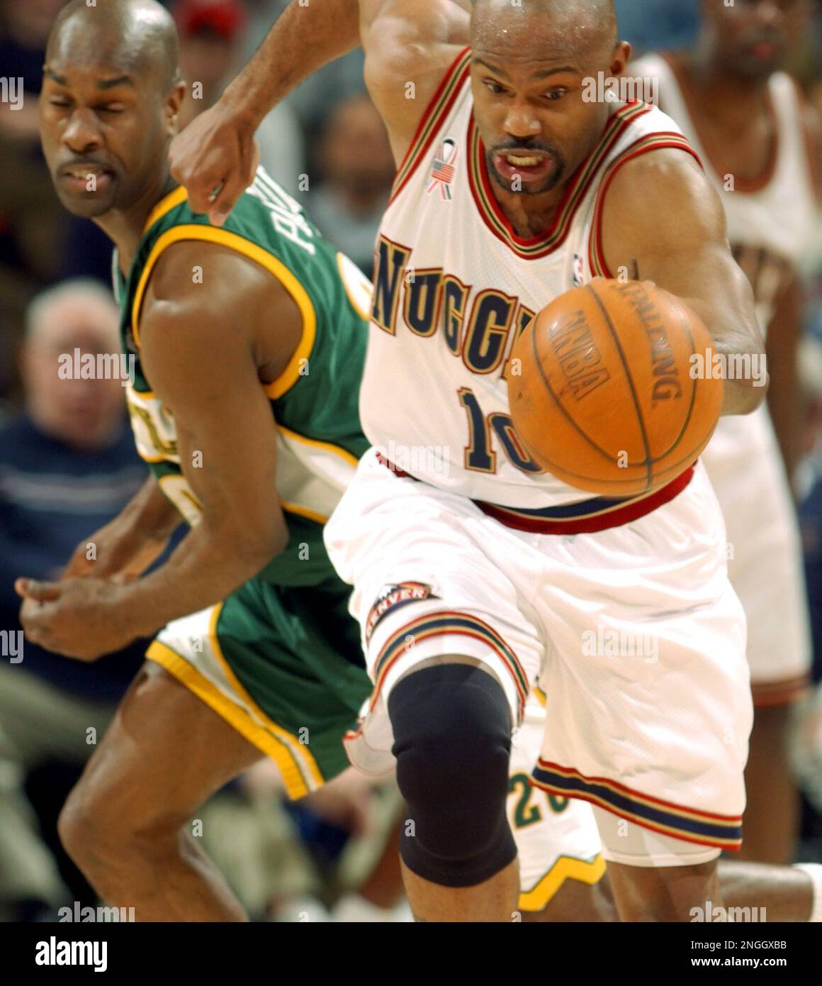 Denver Nuggets guard Tim Hardaway, front, scoops up a loose ball after stripping Seattle ...