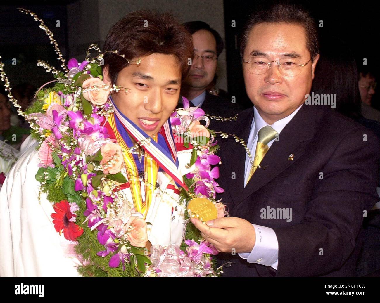 South Korean speed skater Kim Dong-Sung, left, receives a replica of ...