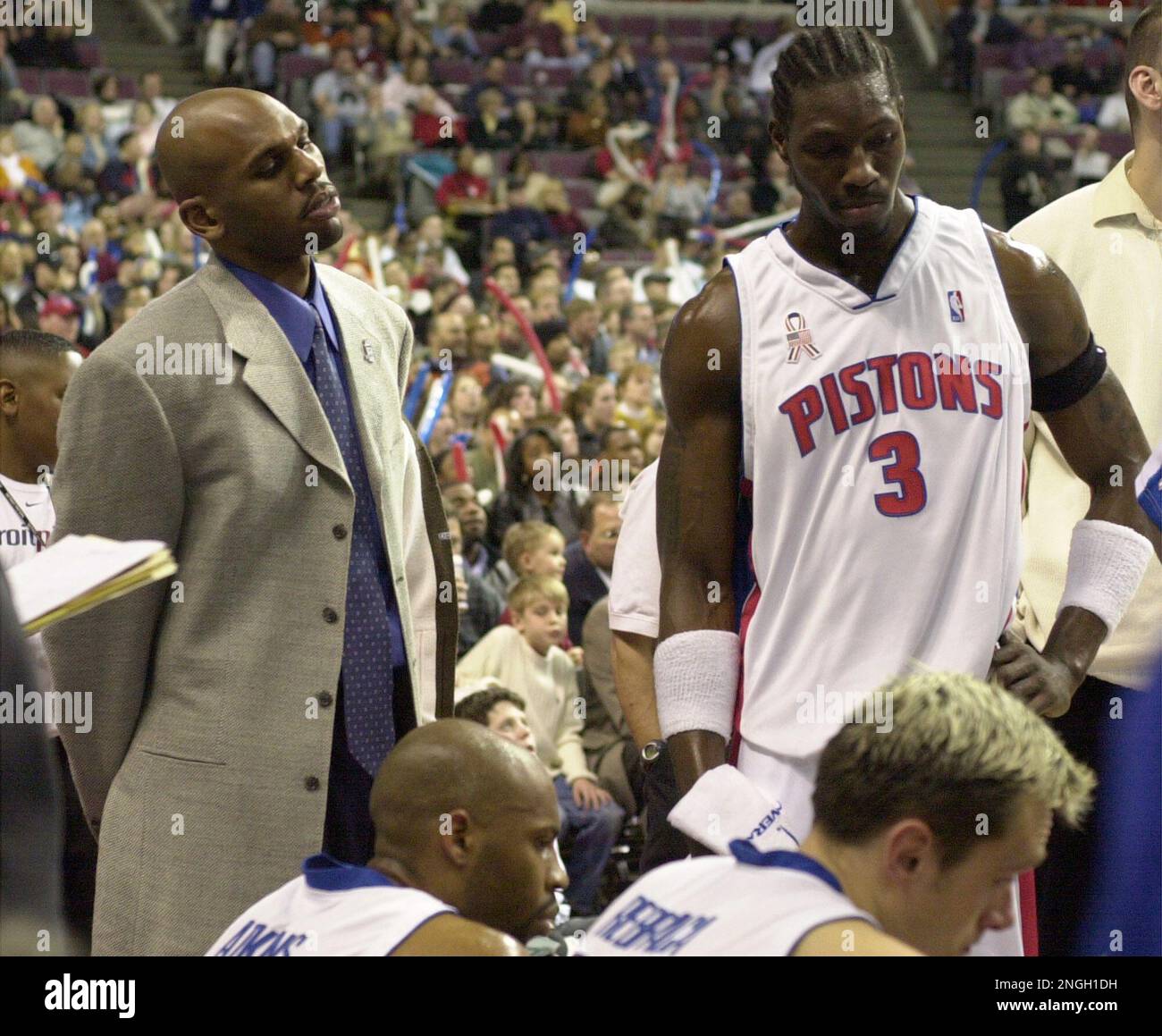Detroit Pistons guard Jerry Stackhouse, left, in streetclothes, listens ...