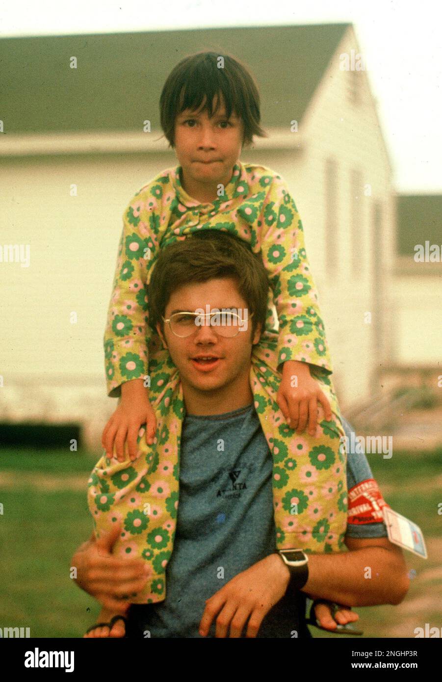 Mark David Chapman gives an unidentified Vietnamese child a ride on his ...