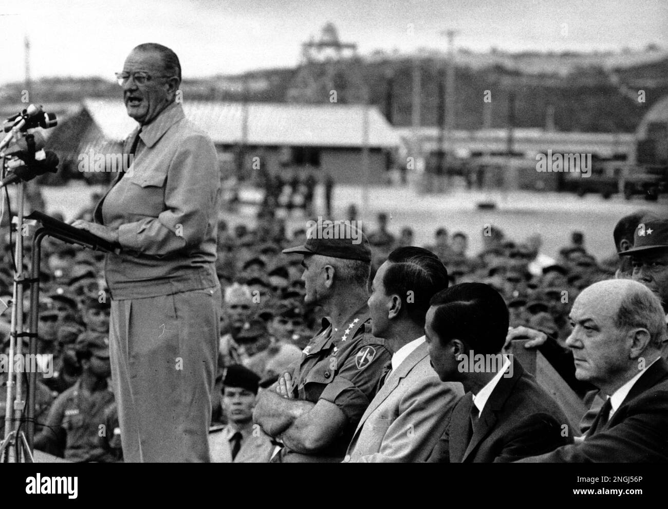 President Johnson, visiting South Vietnam, stands before american ...