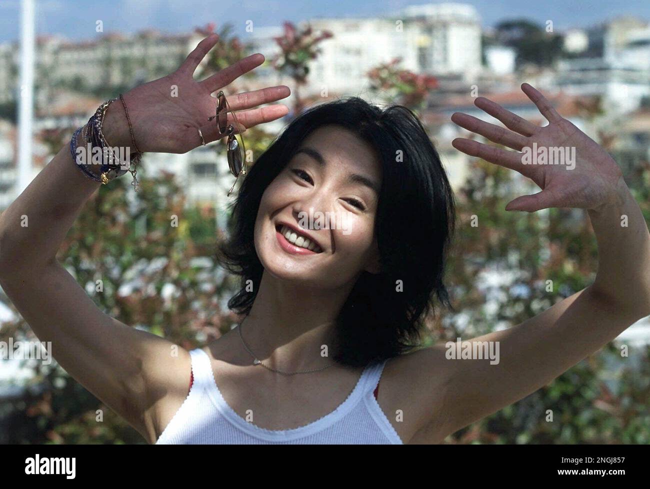 Chinese actress Maggie Cheung Man-Yuk, smiles as she poses during a photocall for the film "In ...