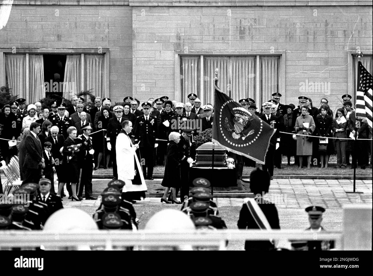 Mrs. Truman is escorted by Lt. Gen. Patrick M. Cassidy past the coffin ...