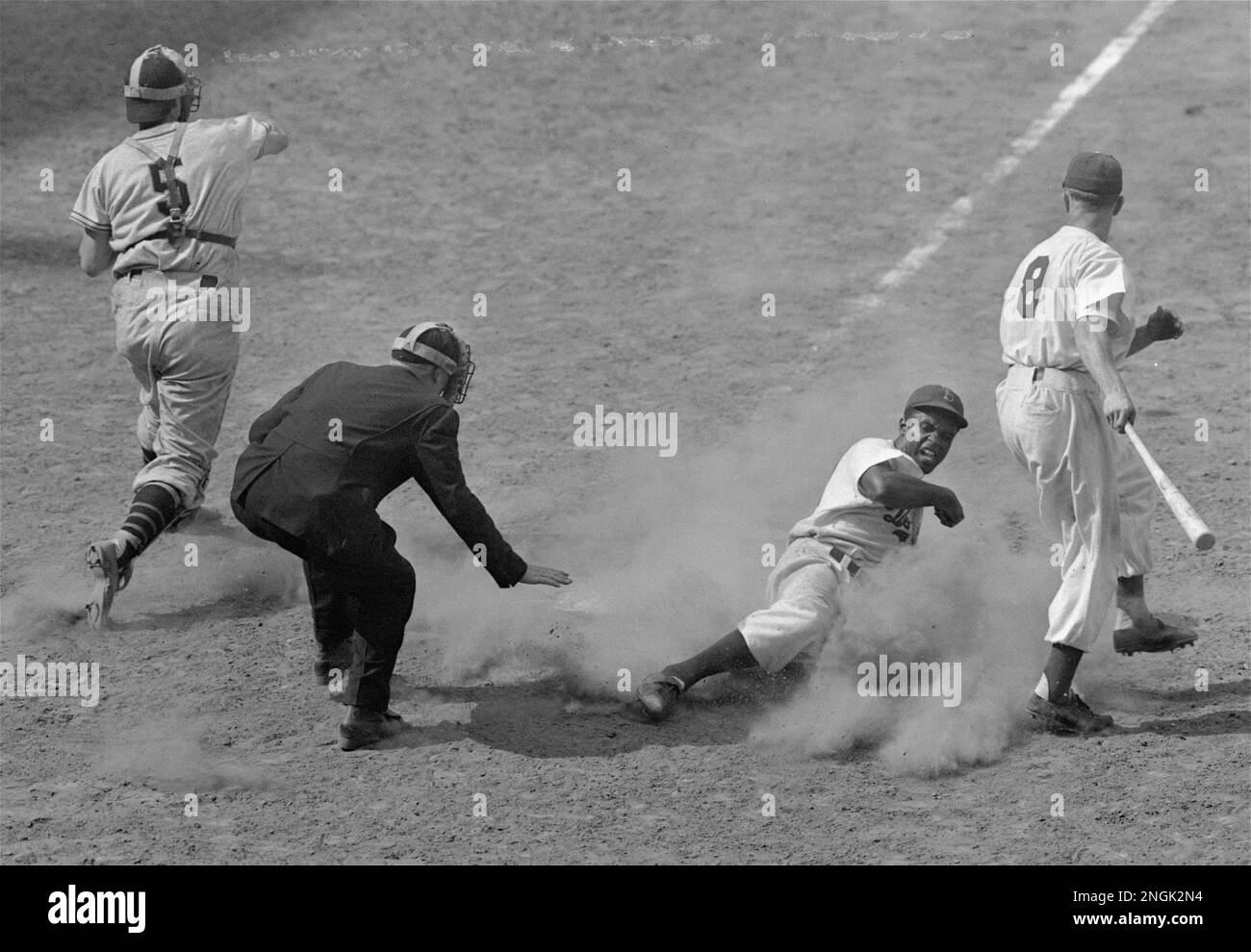 Jackie Robinson, Dodgers' second baseman, crosses home plate on a steal ...