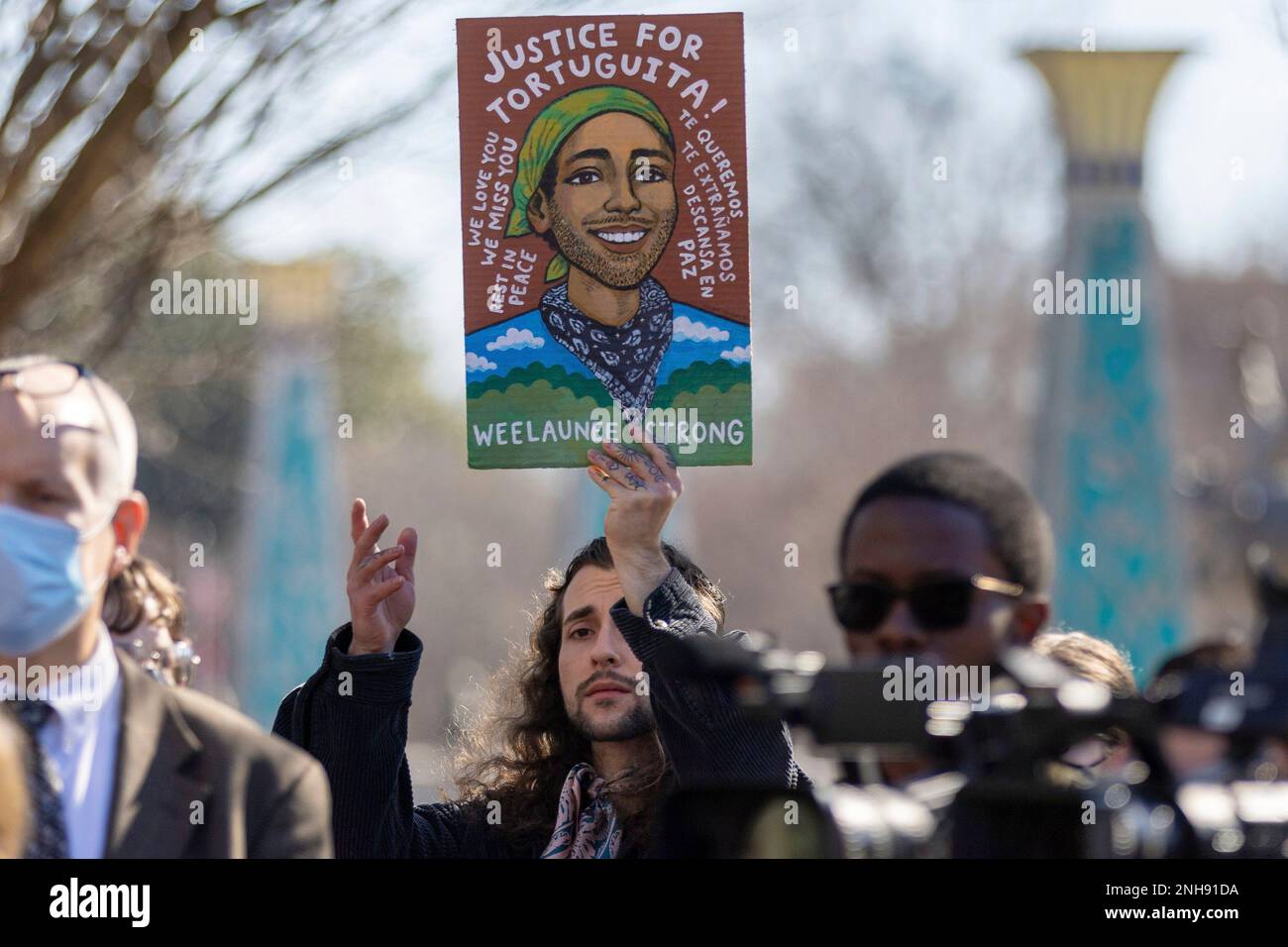 Noah Gringi holds a sign at a press conference for Manuel Esteban Paez ...