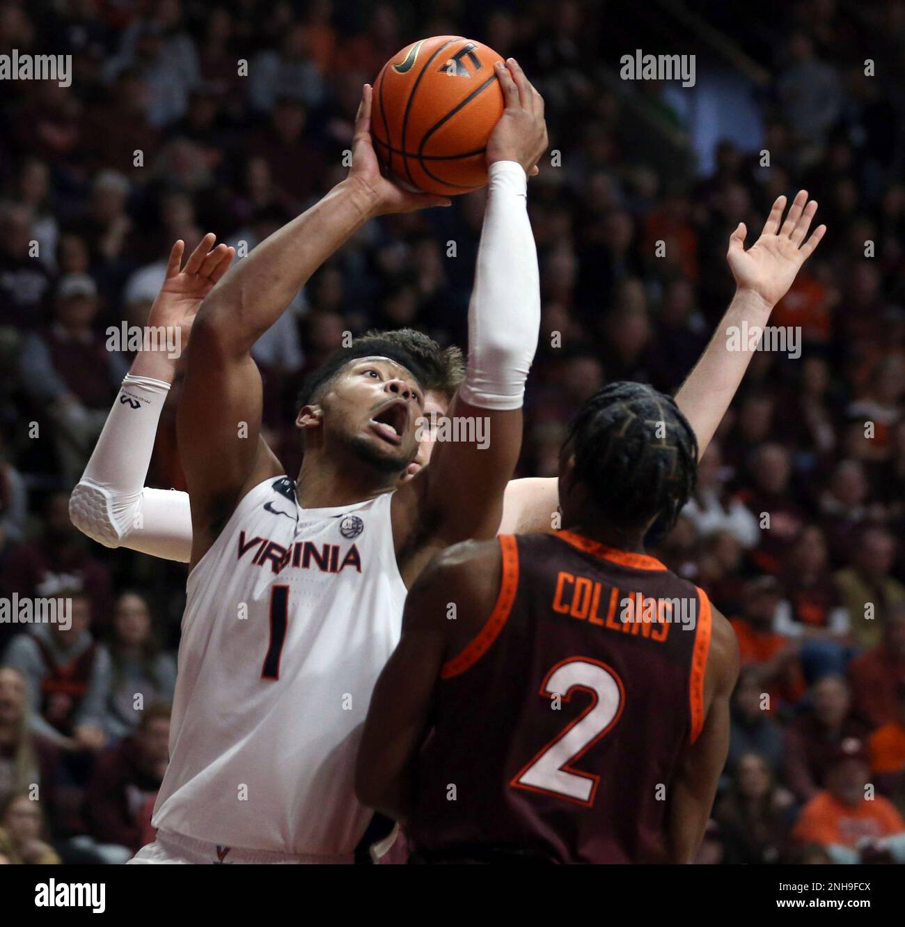 Virginia's Jayden Gardner (1) drives on Virginia Tech's Michael Collins Jr.(2) in the first half ...